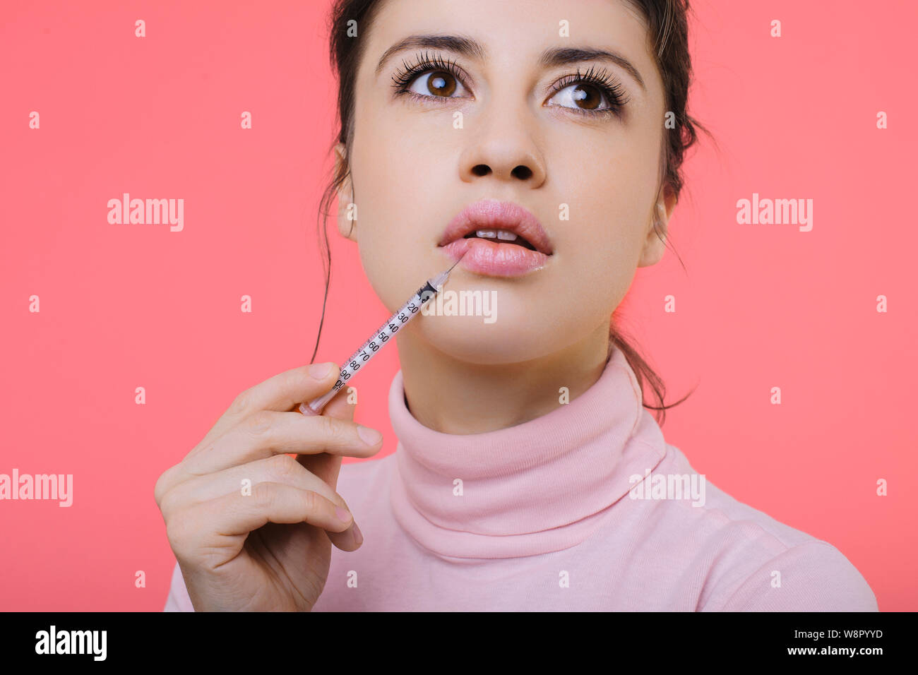 Crop beautiful young thoughtful lady in blouse holding injection of ...