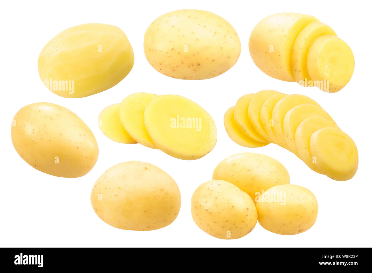 Potatoes (Solanum tuberosum) tubers, whole, peeled and sliced, isolated ...