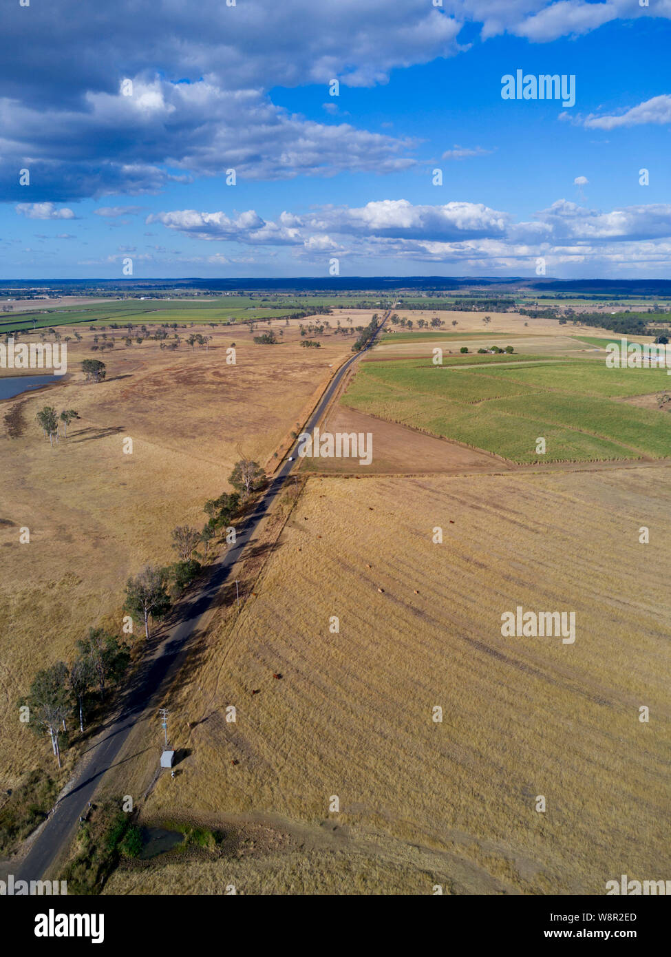 Aerial of country road passing through some very dry land near ...