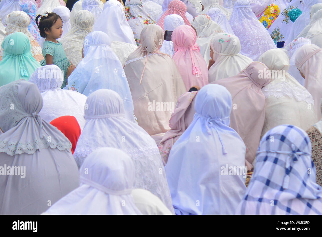 Female muslims perform Eid al-Adha prayer in congregation in a field in ...