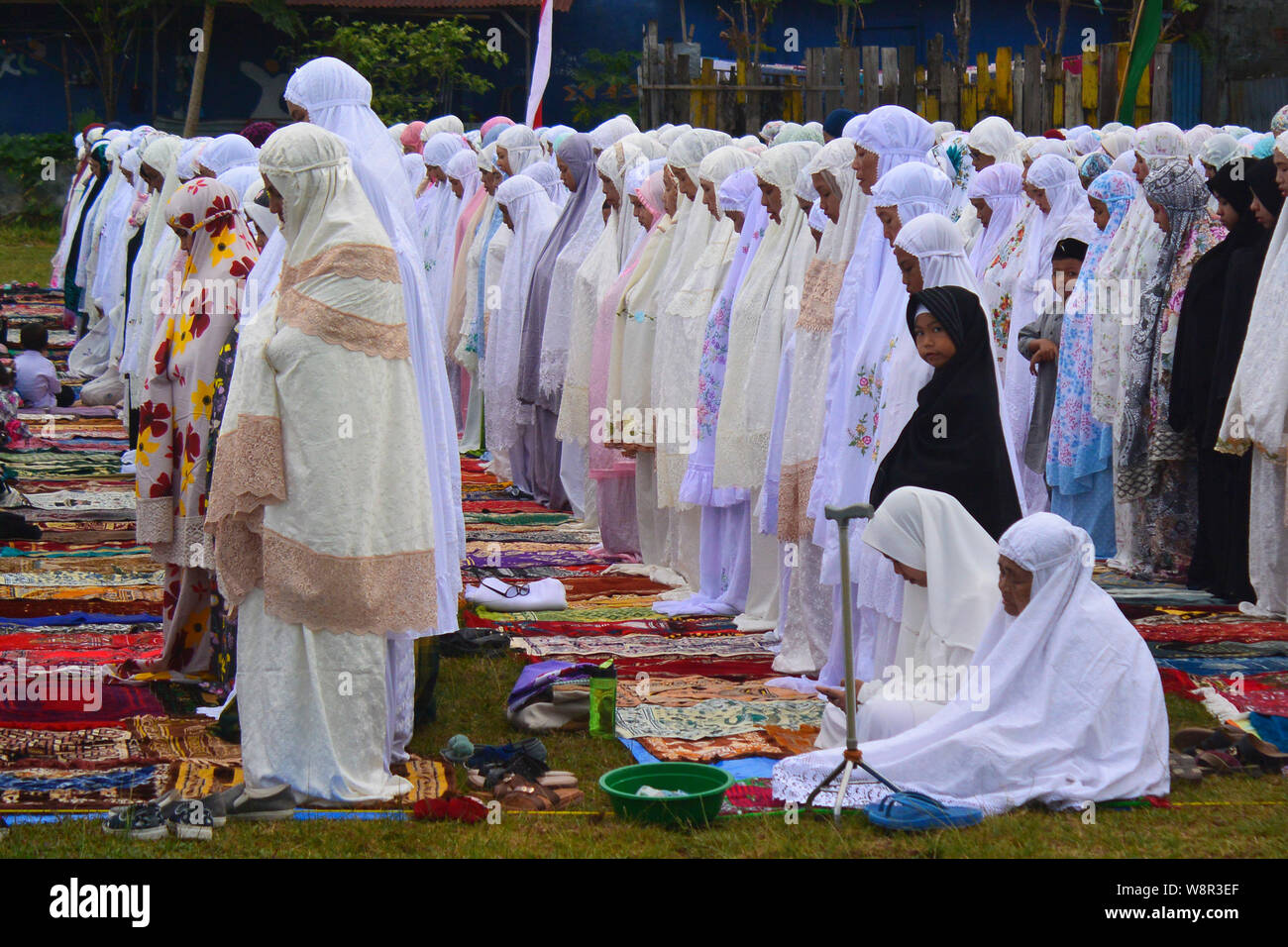 Female muslims perform Eid al-Adha prayer in congregation in a field in ...