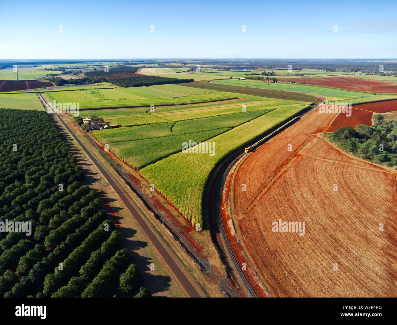 Aerial of a sugar cane train hauling a load of freshly cut sugar cane ...