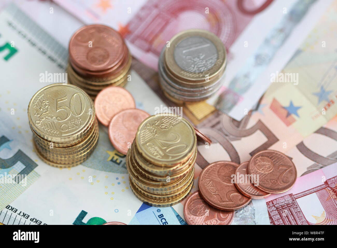 Banknotes and small change on a table Stock Photo - Alamy