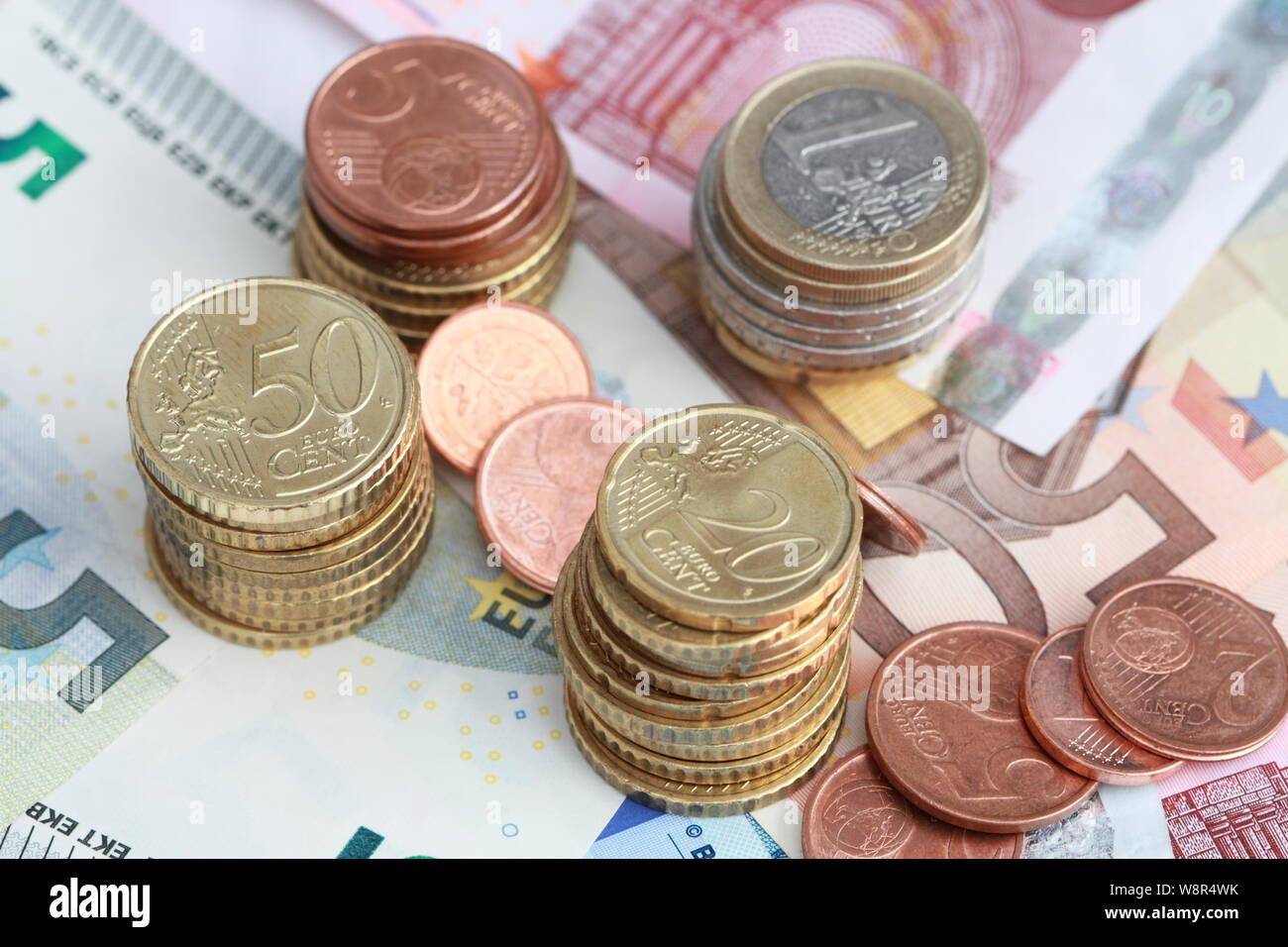 Banknotes and small change on a table Stock Photo - Alamy
