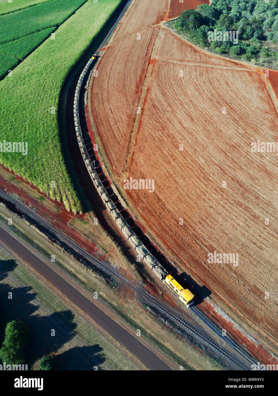 Aerial of a sugar cane train hauling a load of freshly cut sugar cane ...