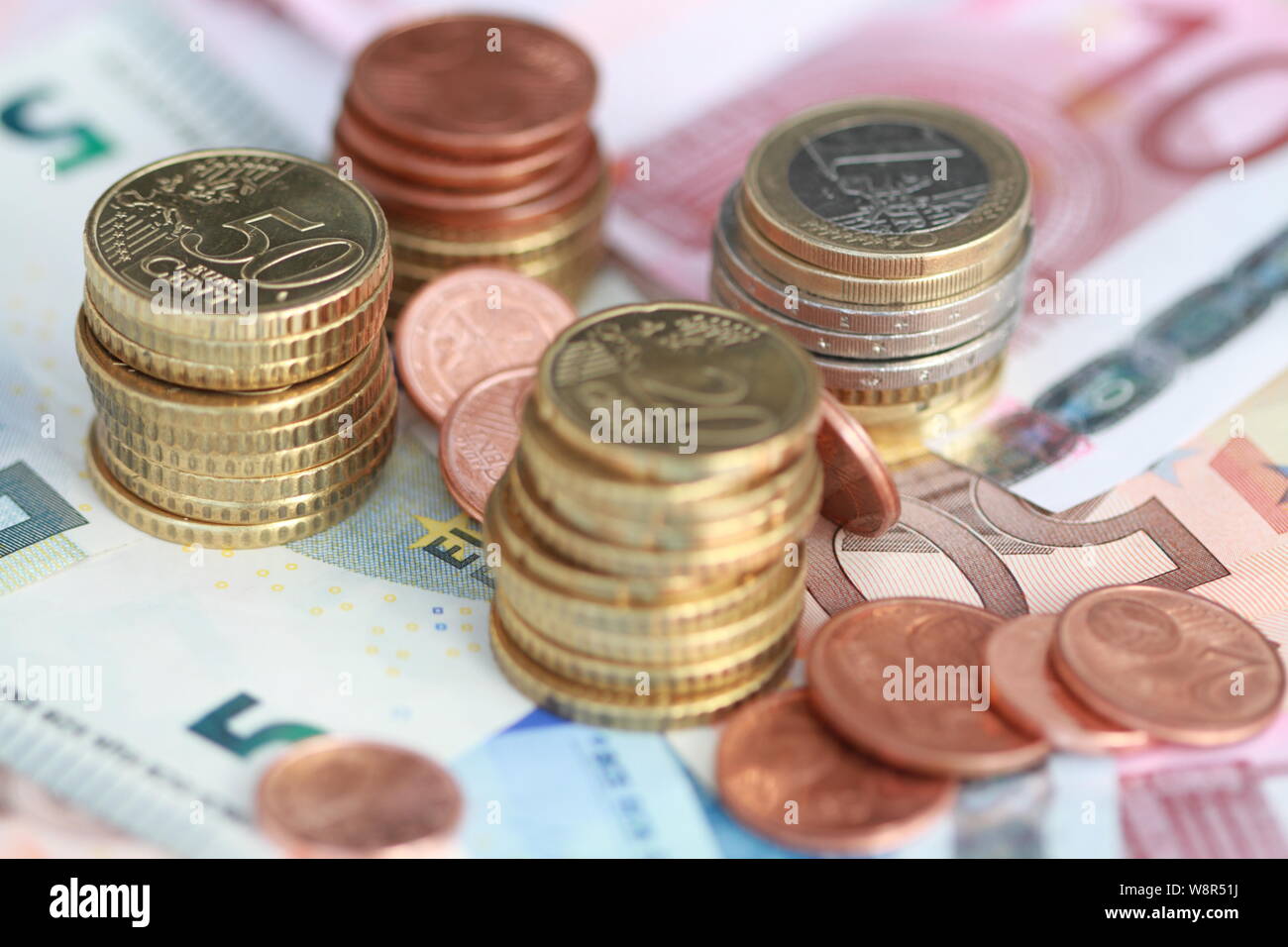 Banknotes and small change on a table Stock Photo - Alamy