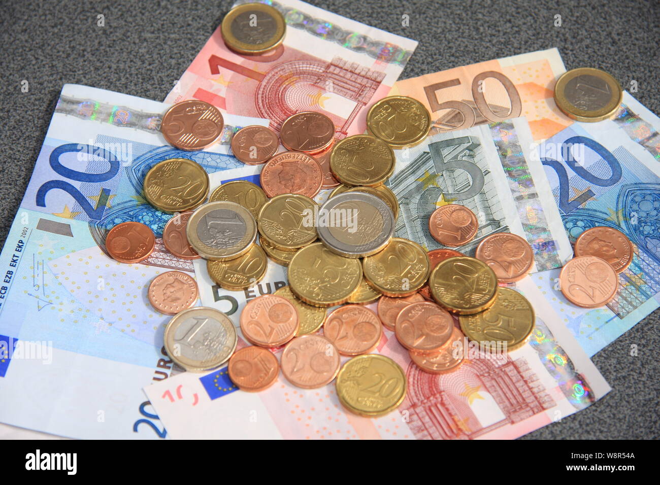 Banknotes and small change on a table Stock Photo - Alamy