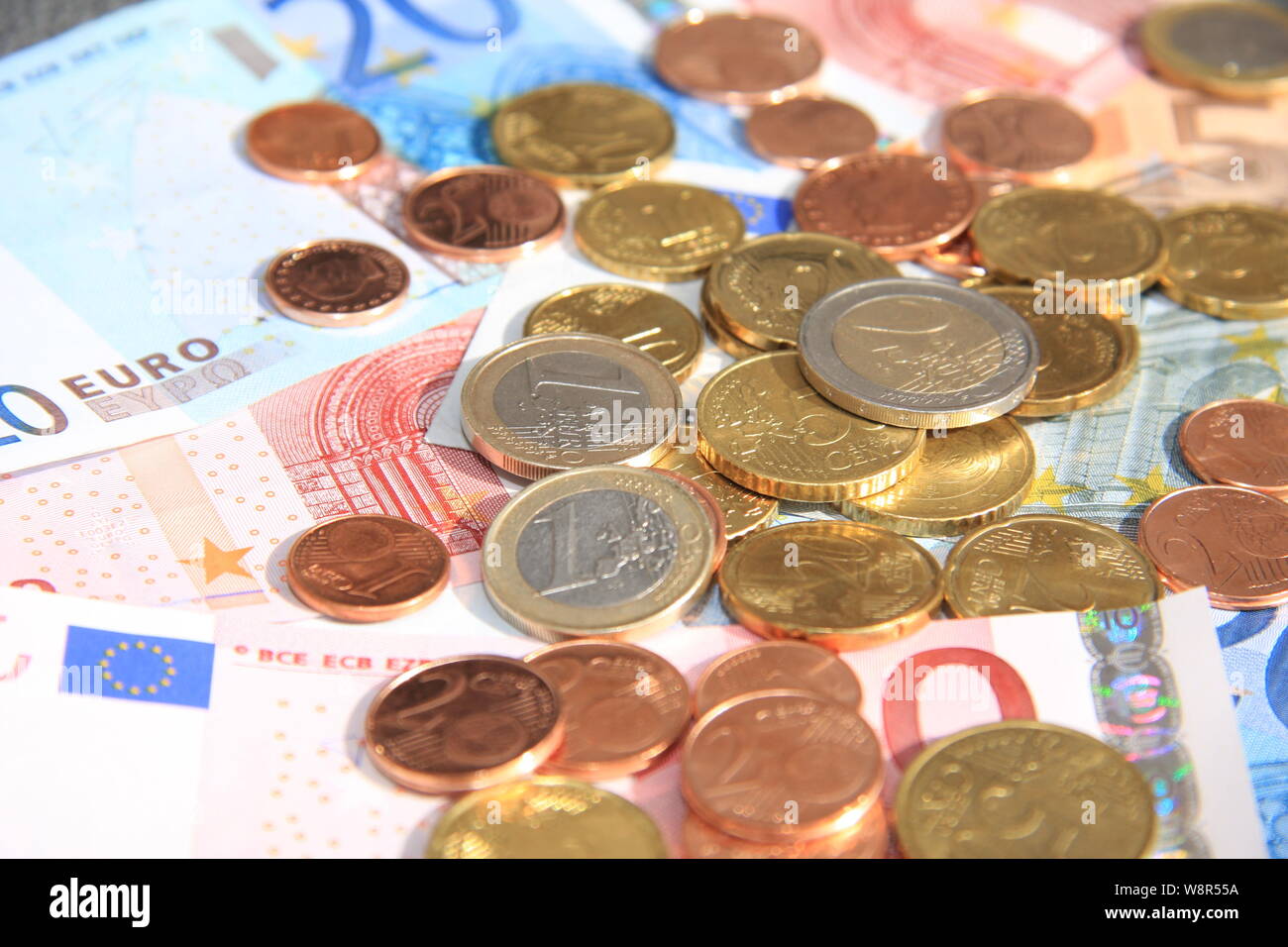 Banknotes and small change on a table Stock Photo - Alamy