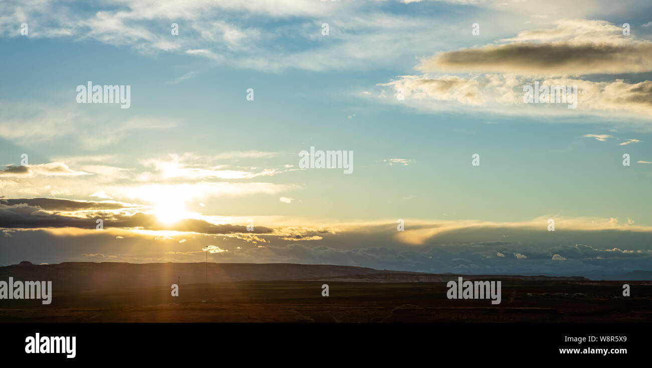 Sun falling, blue sky background with clouds, sunset in the US ...
