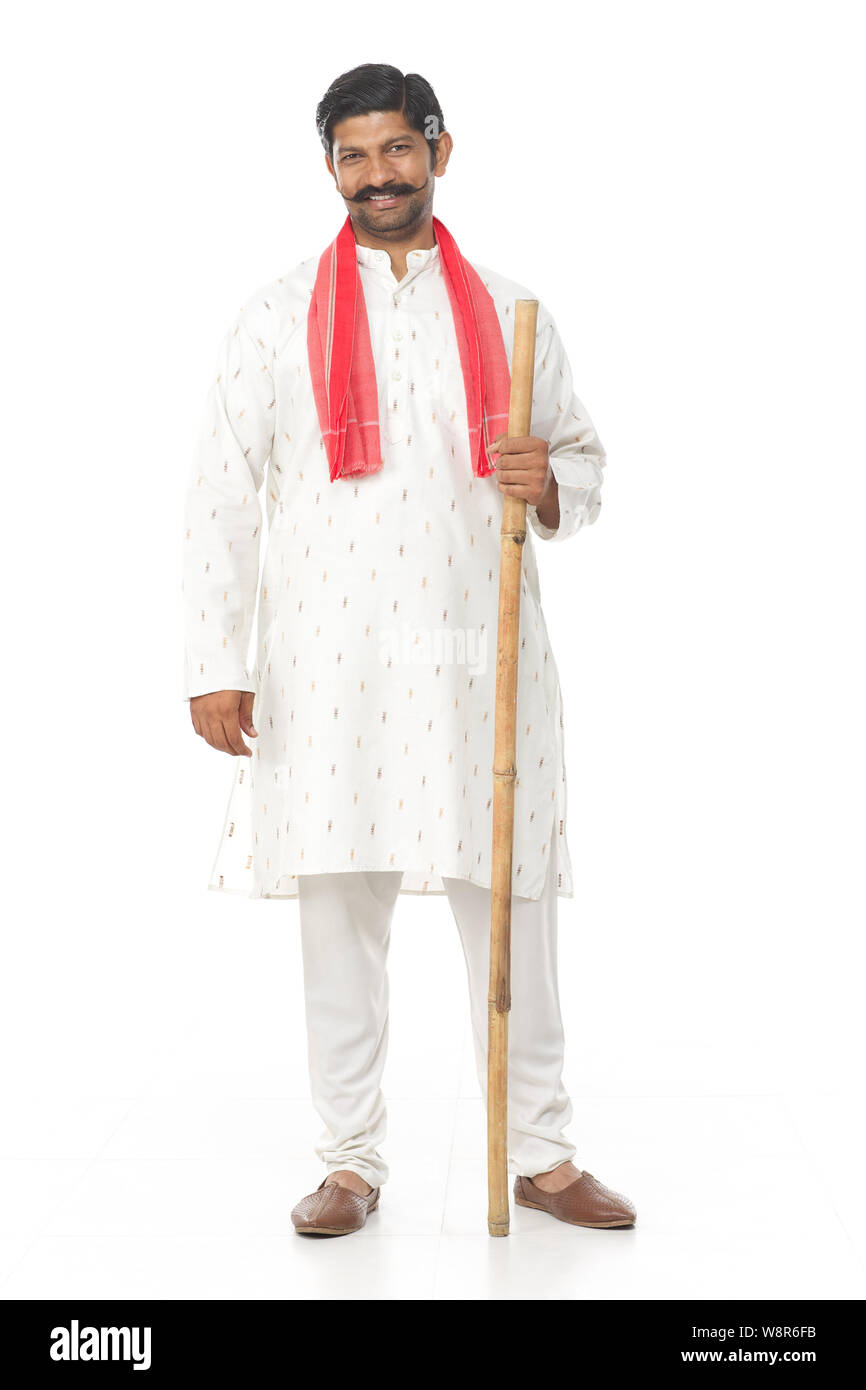 Rural man standing with his cane Stock Photo - Alamy