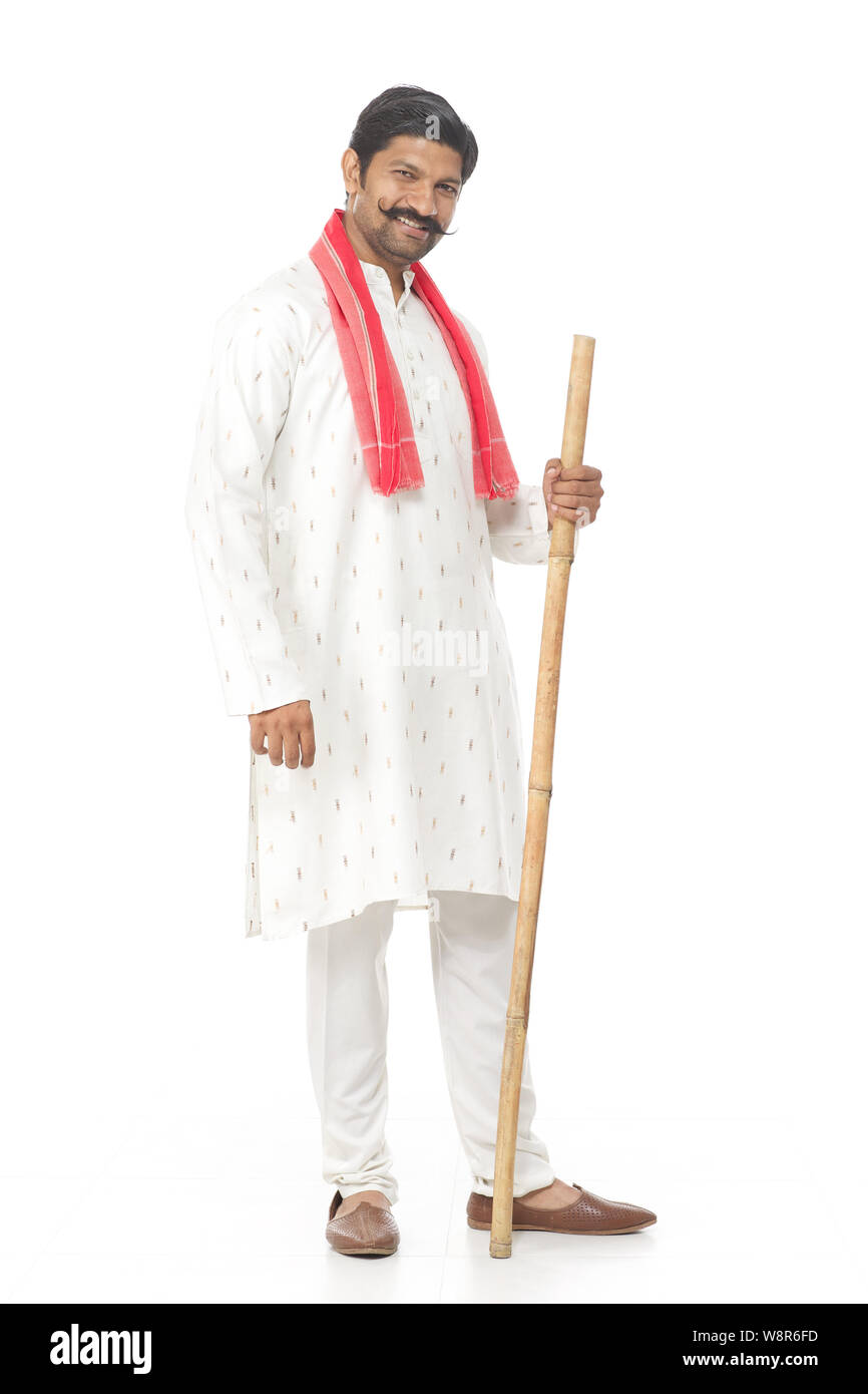 Rural man standing with his cane Stock Photo - Alamy