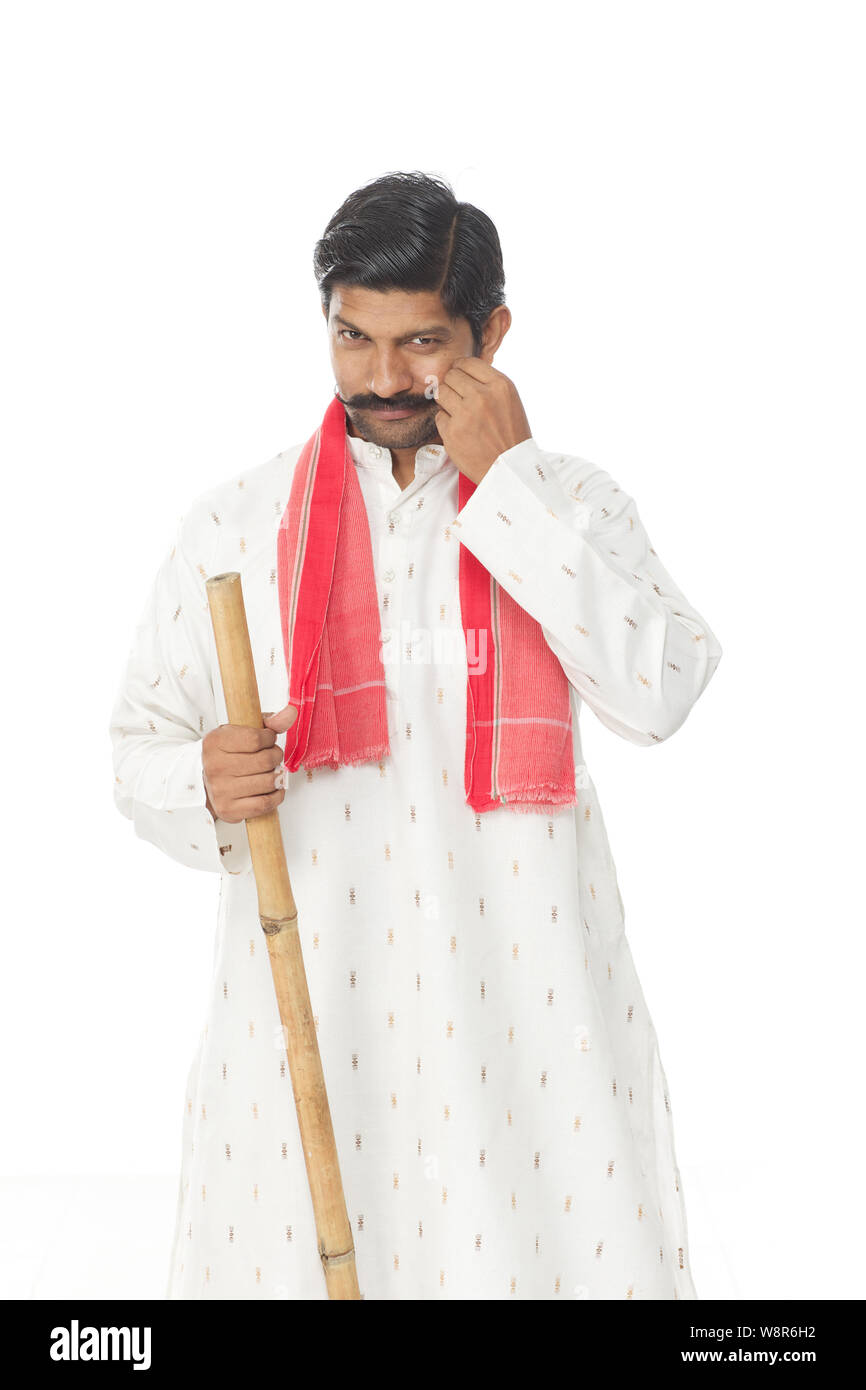 Rural man standing with his cane Stock Photo - Alamy