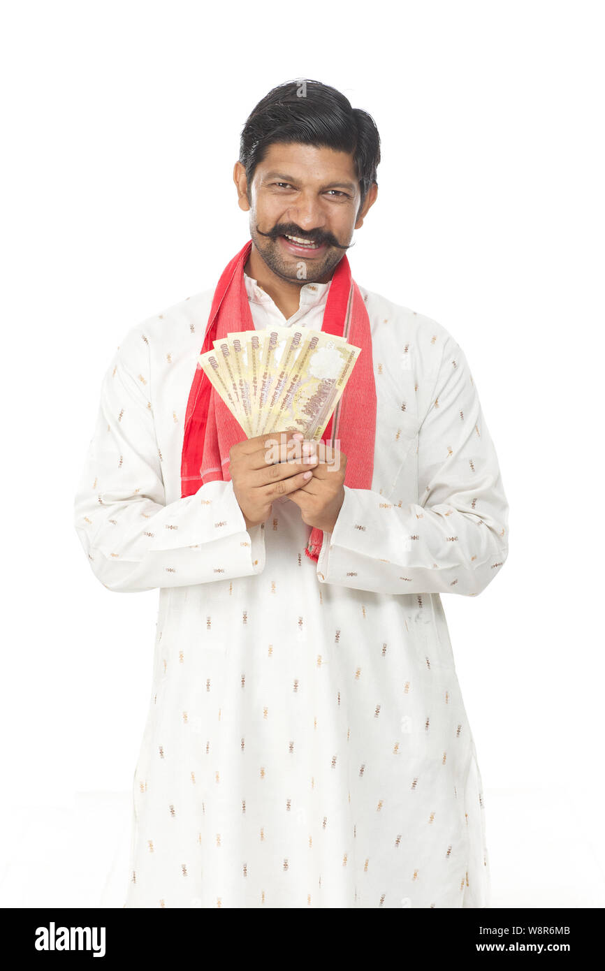 Rural man smiling and showing banknotes Stock Photo - Alamy
