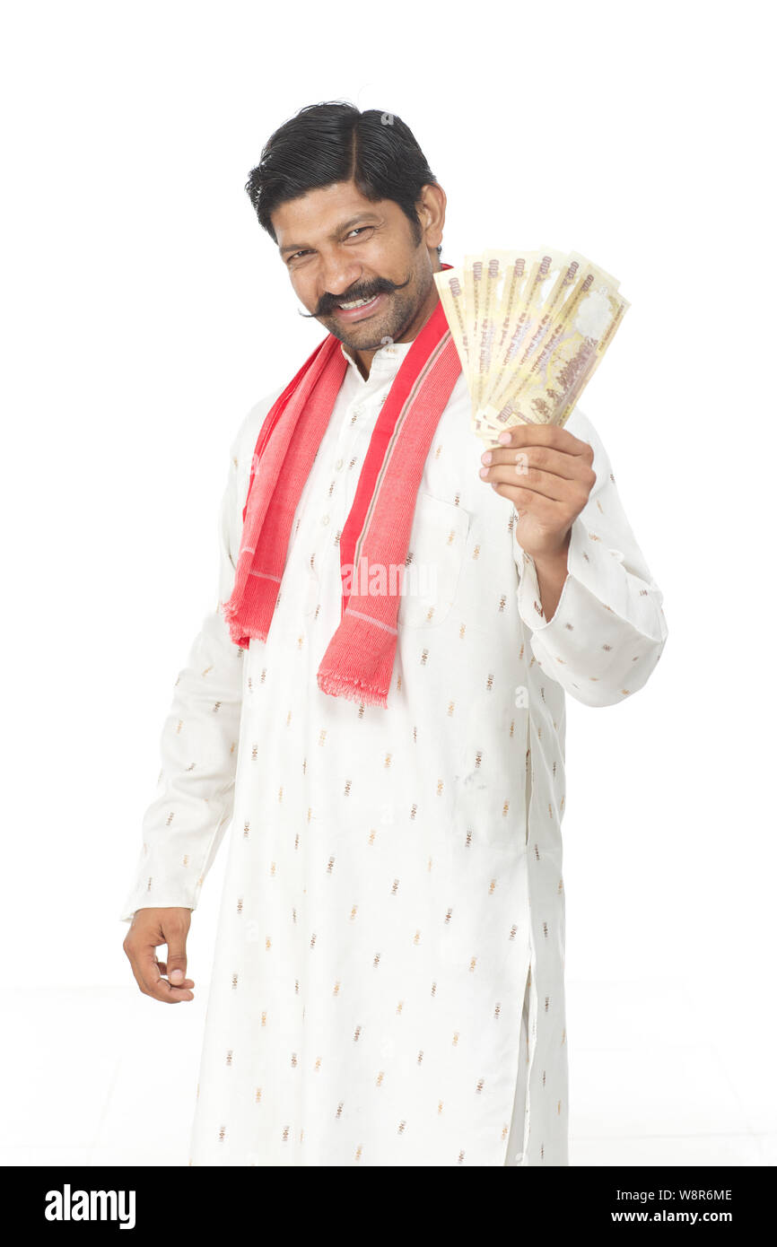 Rural man smiling and showing banknotes Stock Photo - Alamy