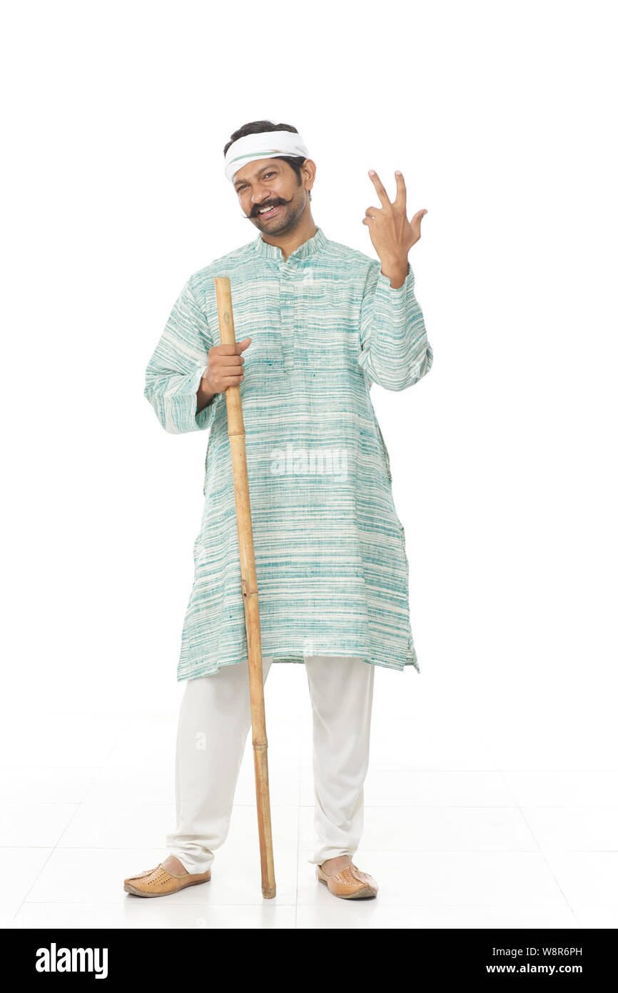 Rural man standing with his cane Stock Photo - Alamy