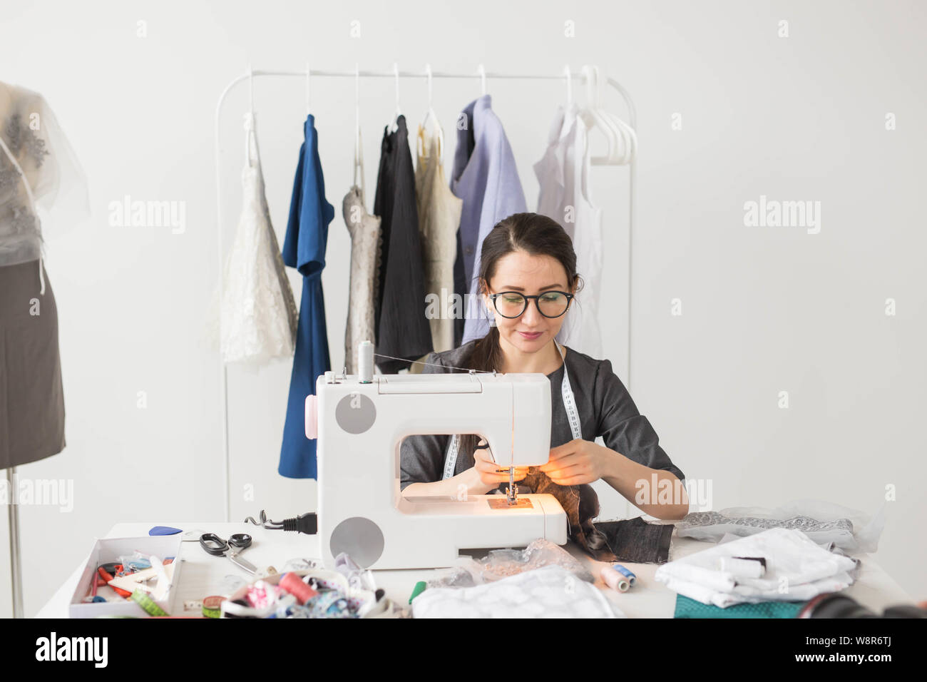 Dressmaker, tailor and fashion concept - Smiling female fashion ...