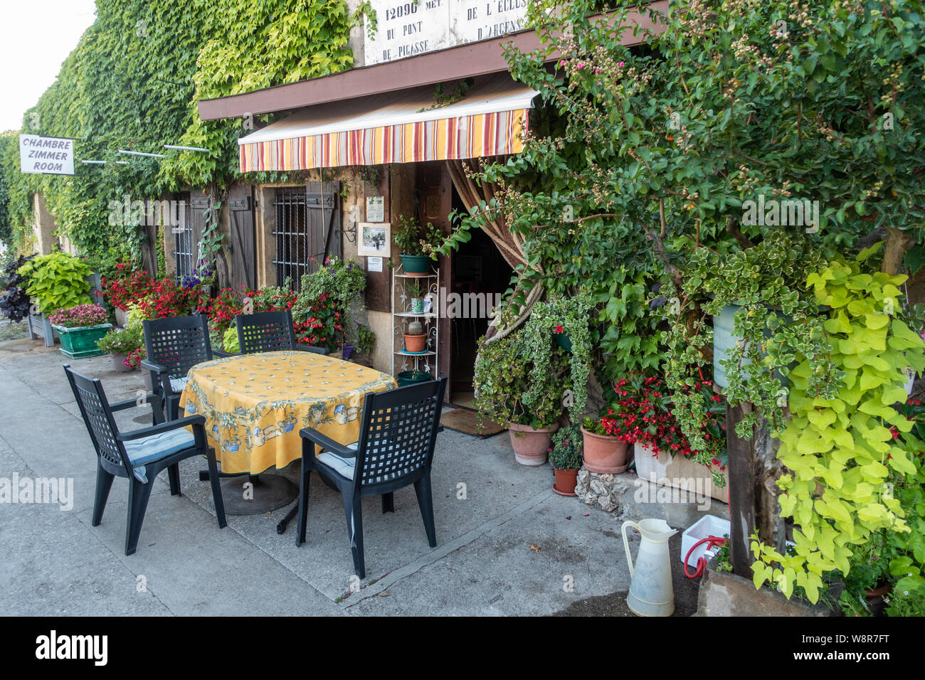 Dining area and tables on a French restaurant terrace in Somail, France ...