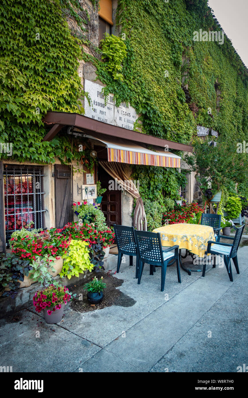 Dining area and tables on a French restaurant terrace in Somail, France ...