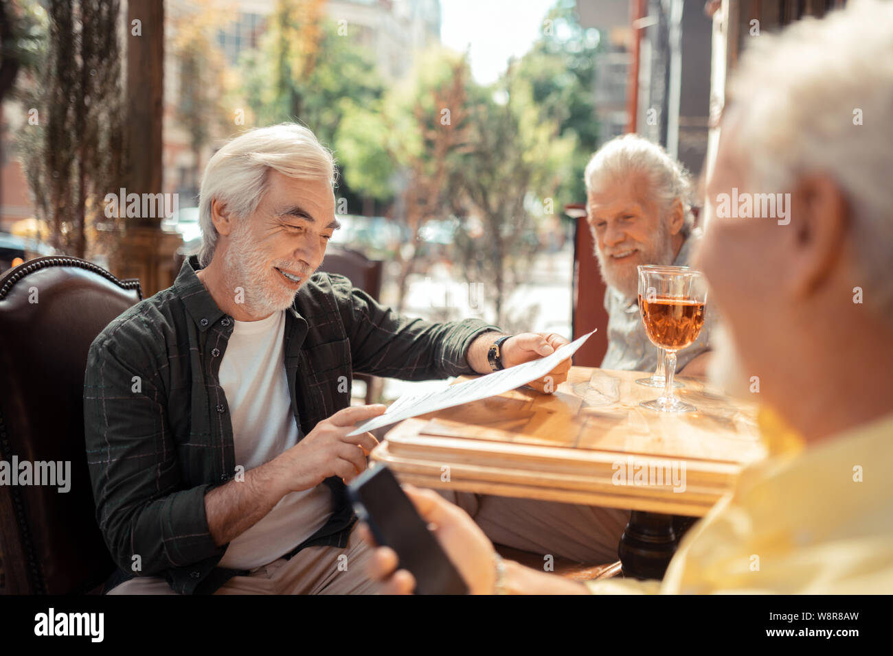 Three retired men celebrating their meeting after ages Stock Photo - Alamy