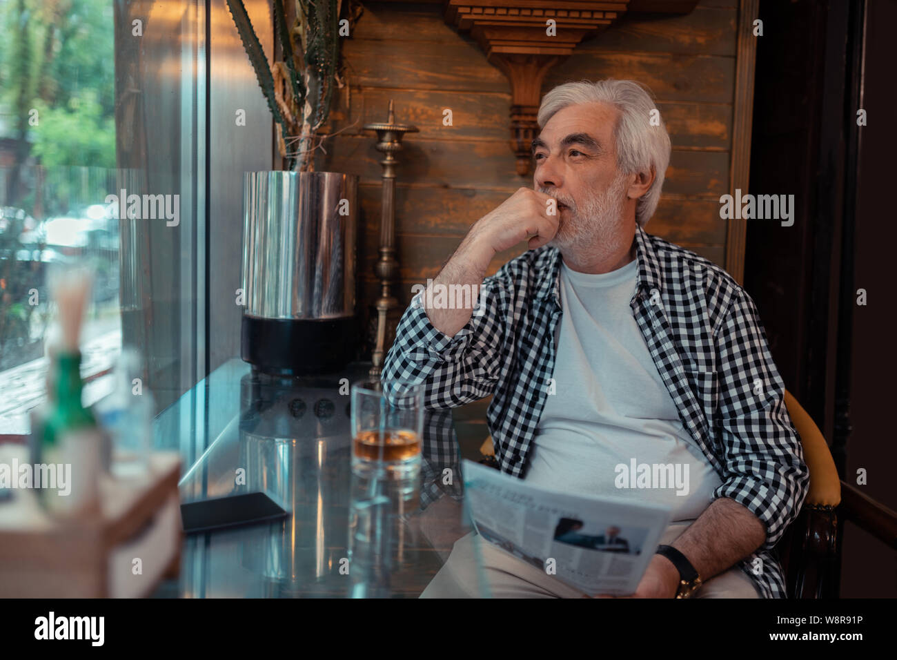 Thoughtful retired man sitting hi-res stock photography and images - Alamy