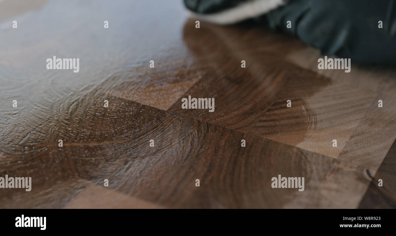woodworker applying oil finish to walnut end grain wood board, wide ...