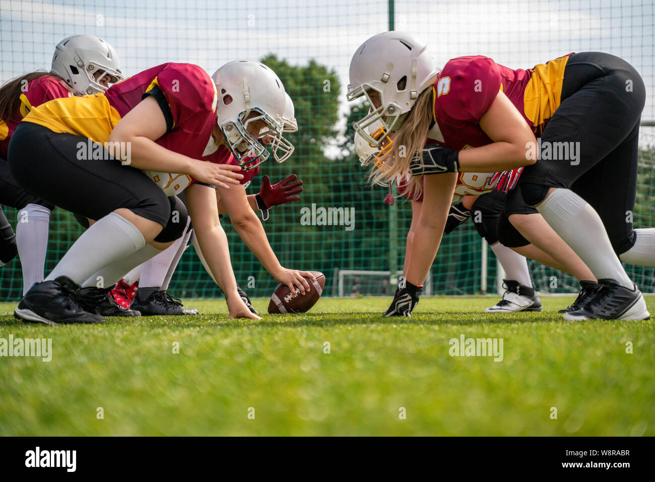 Photo of athletes wearing helmets playing american football on sports ...