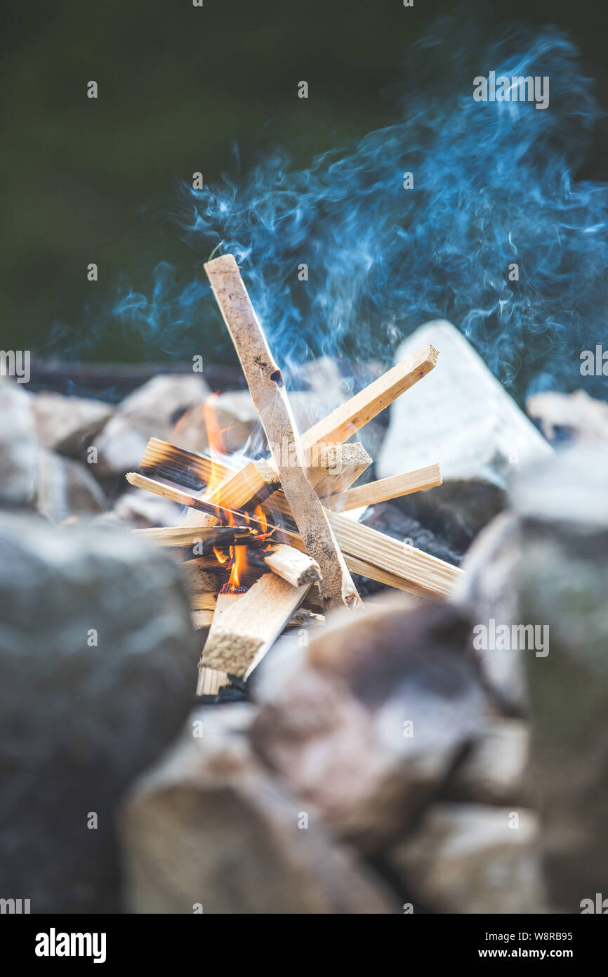 Making fire in the wood, camping outdoors Stock Photo - Alamy