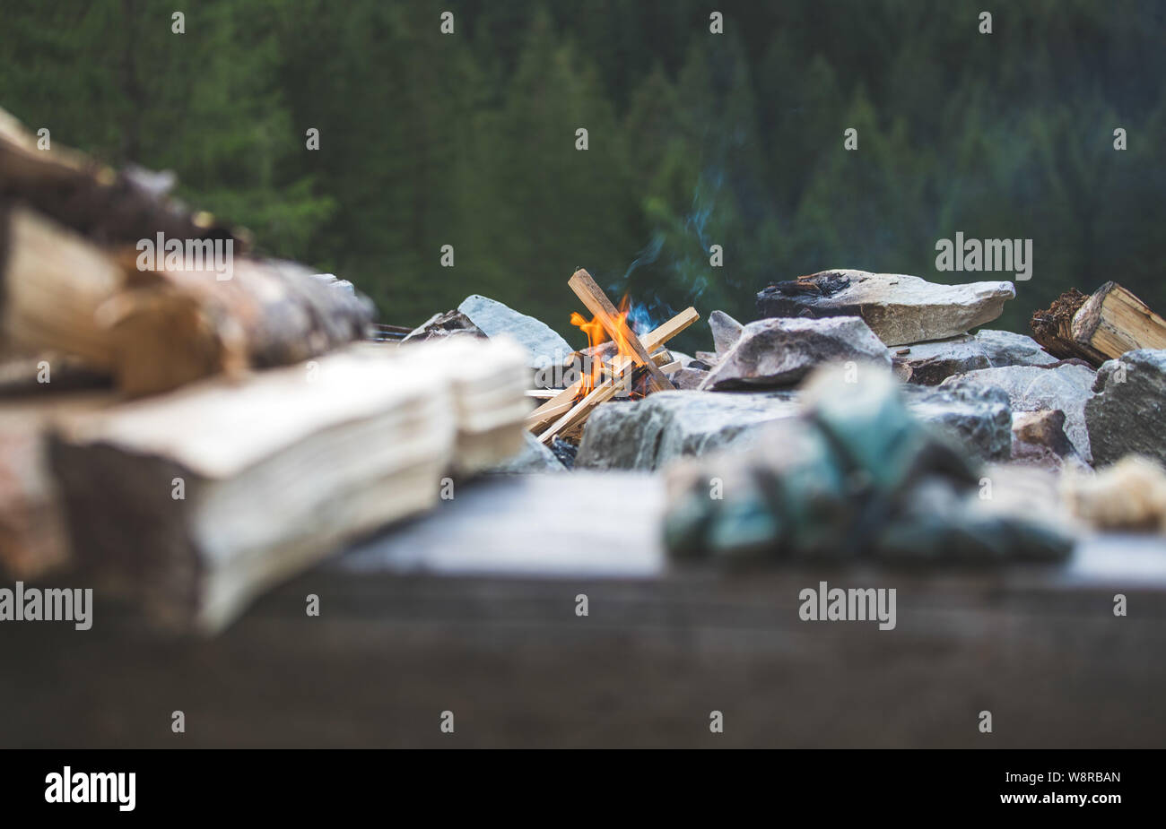 Making fire in the wood, camping outdoors Stock Photo - Alamy