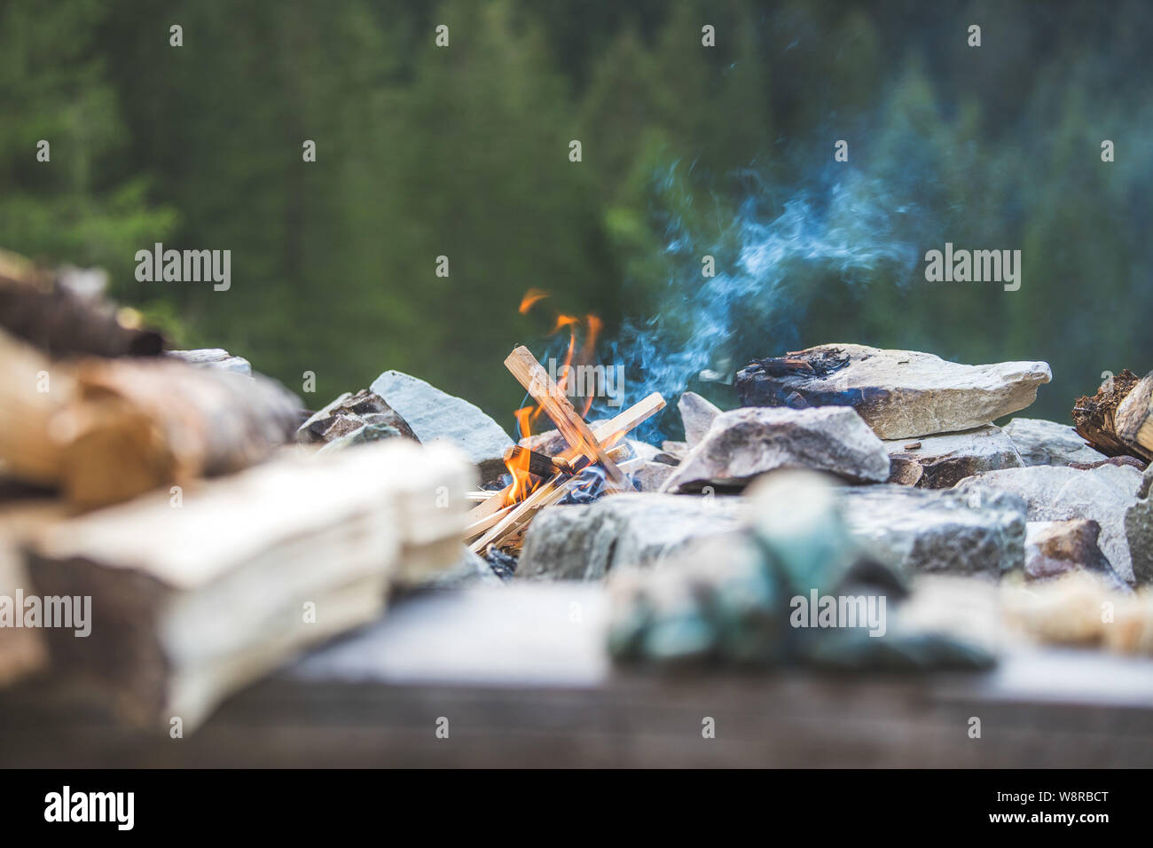 Making fire in the wood, camping outdoors Stock Photo - Alamy