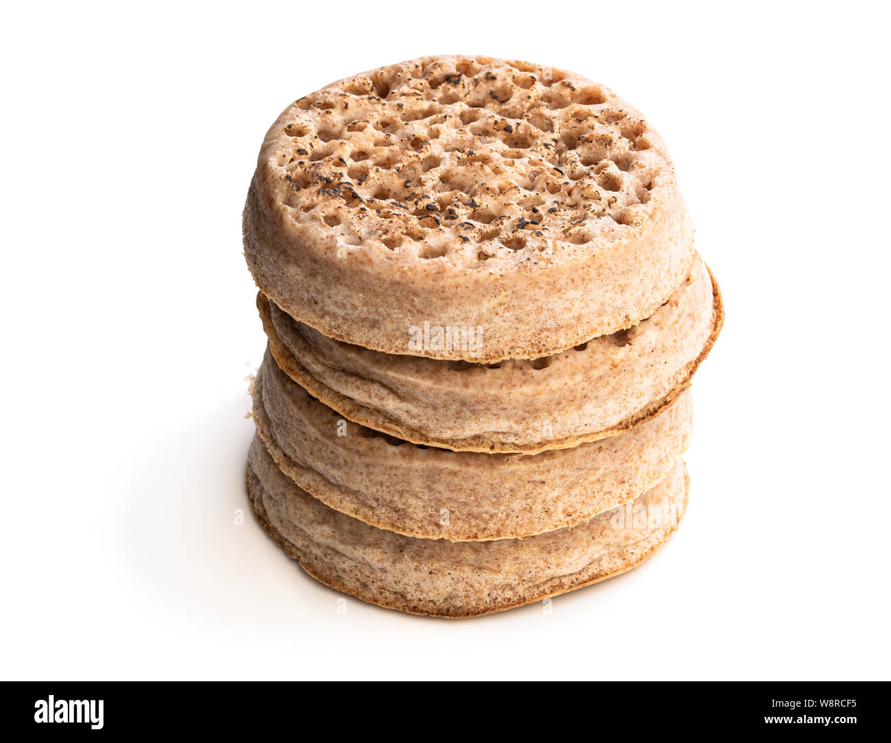 Stack of wholemeal crumpets isolated on white background Stock Photo ...