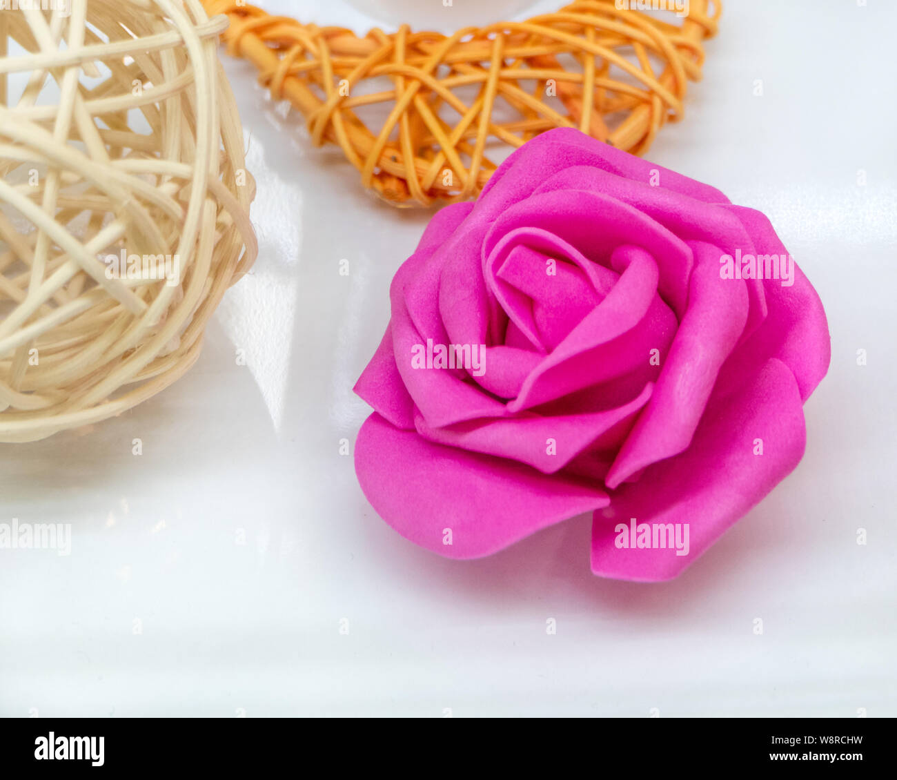 Rattan ball and material flower on white Stock Photo - Alamy