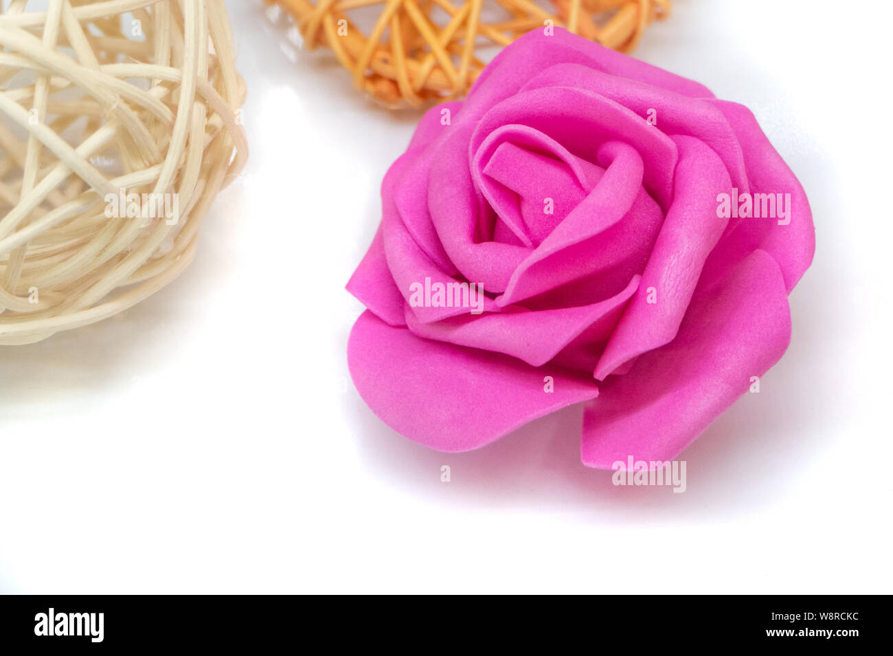 Rattan ball and material flower on white Stock Photo - Alamy