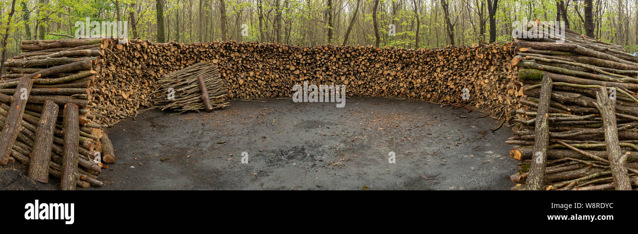 stacked logs for creating a pyre in the making of charcoal Stock Photo ...