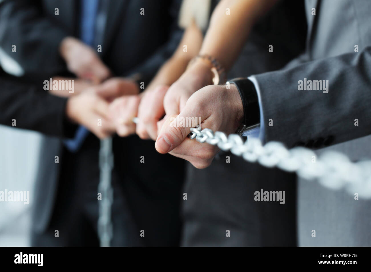 Businessmen pulling chain, teamwork togetherness concept Stock Photo ...