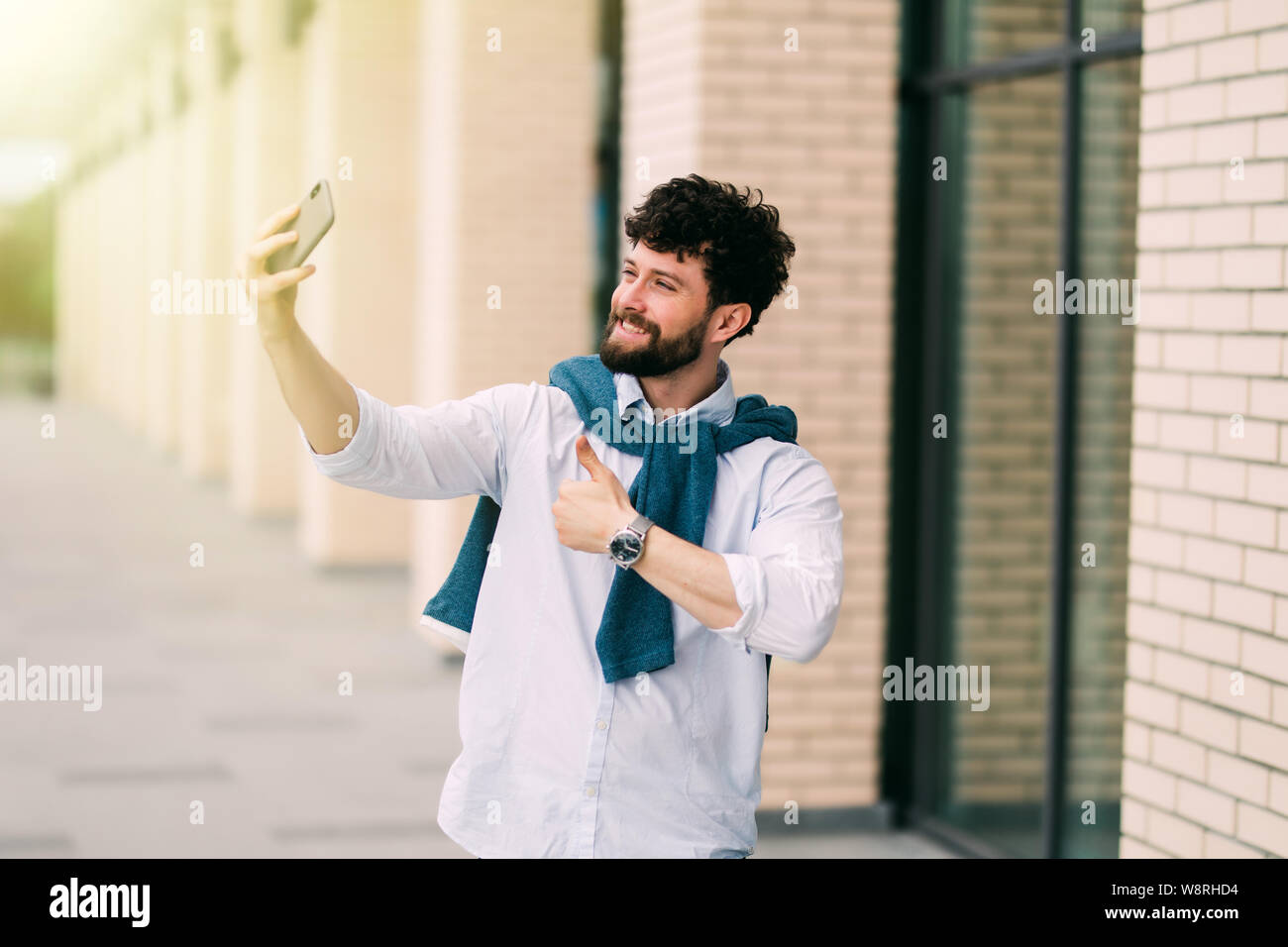 Selfie. Excited young guy is making selfie on a camera on a walk in ...