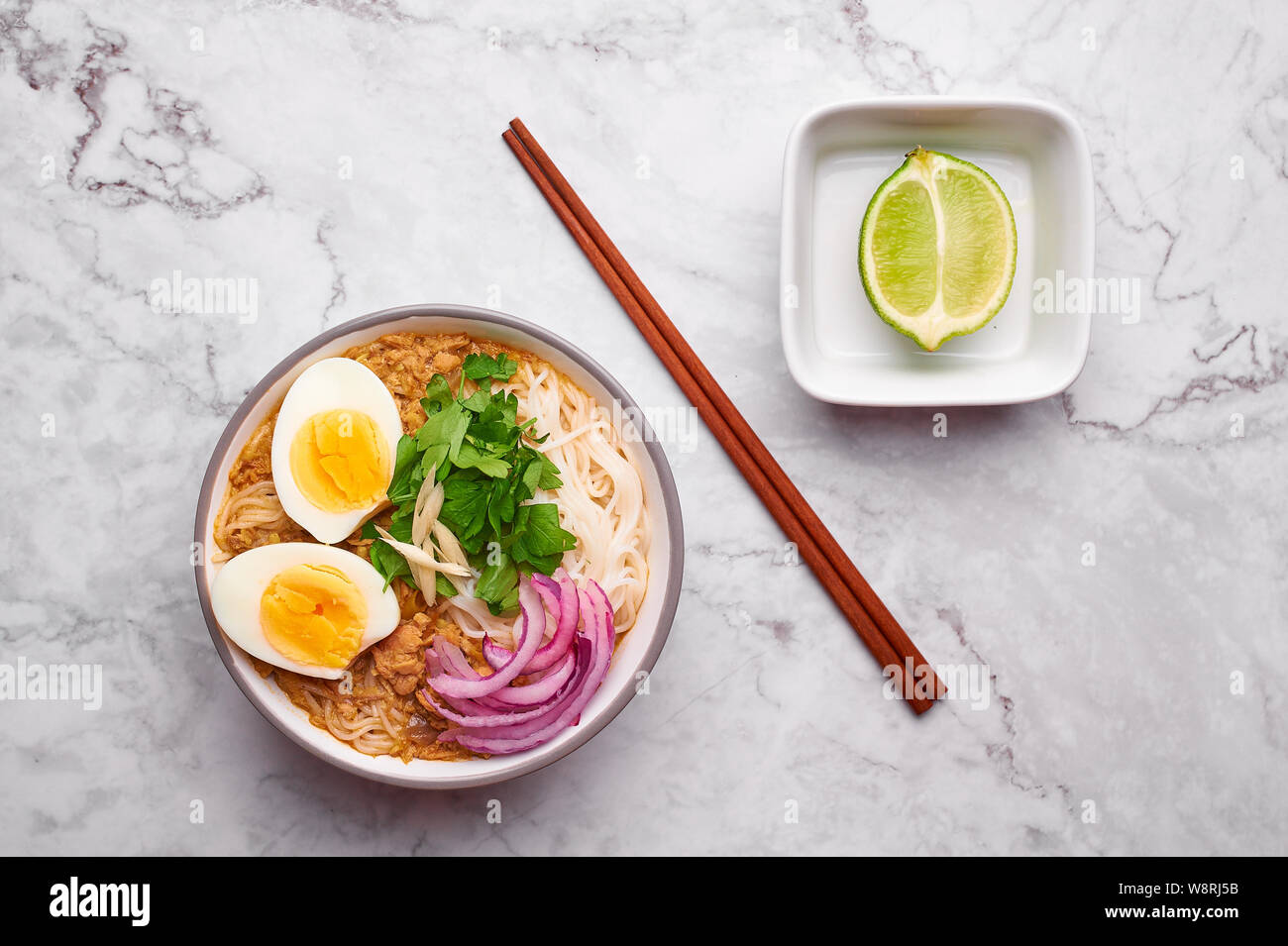 Mohinga at white marble background. Mohinga is a burmese cuisine fish ...