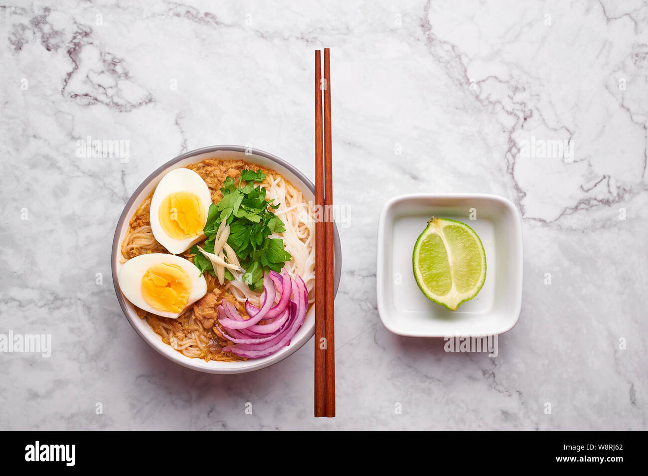 Mohinga at white marble background. Mohinga is a burmese cuisine fish ...