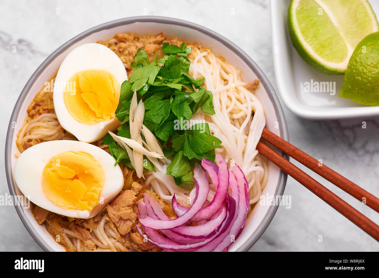 Mohinga at white marble background. Mohinga is a burmese cuisine fish ...