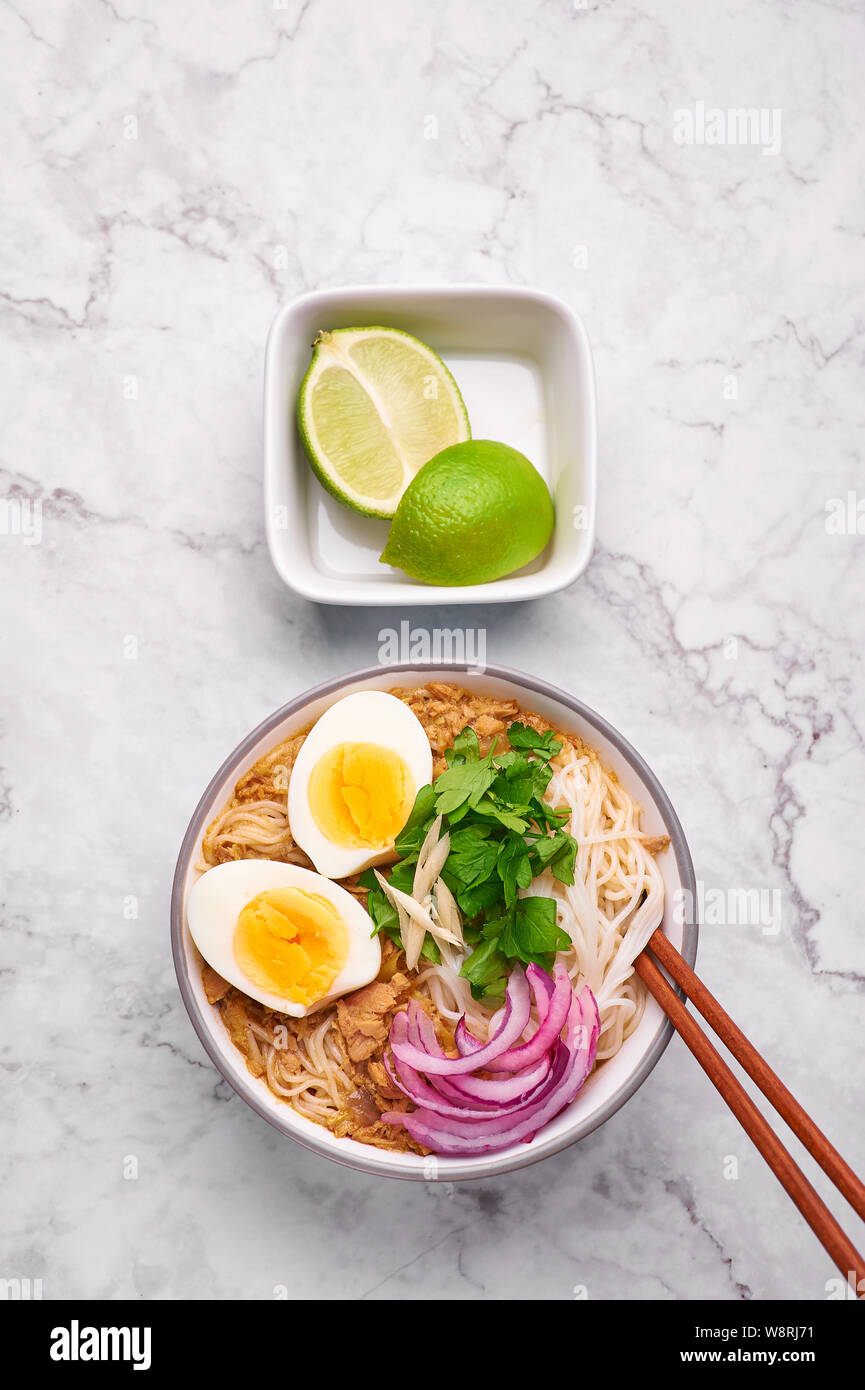 Mohinga at white marble background. Mohinga is a burmese cuisine fish ...