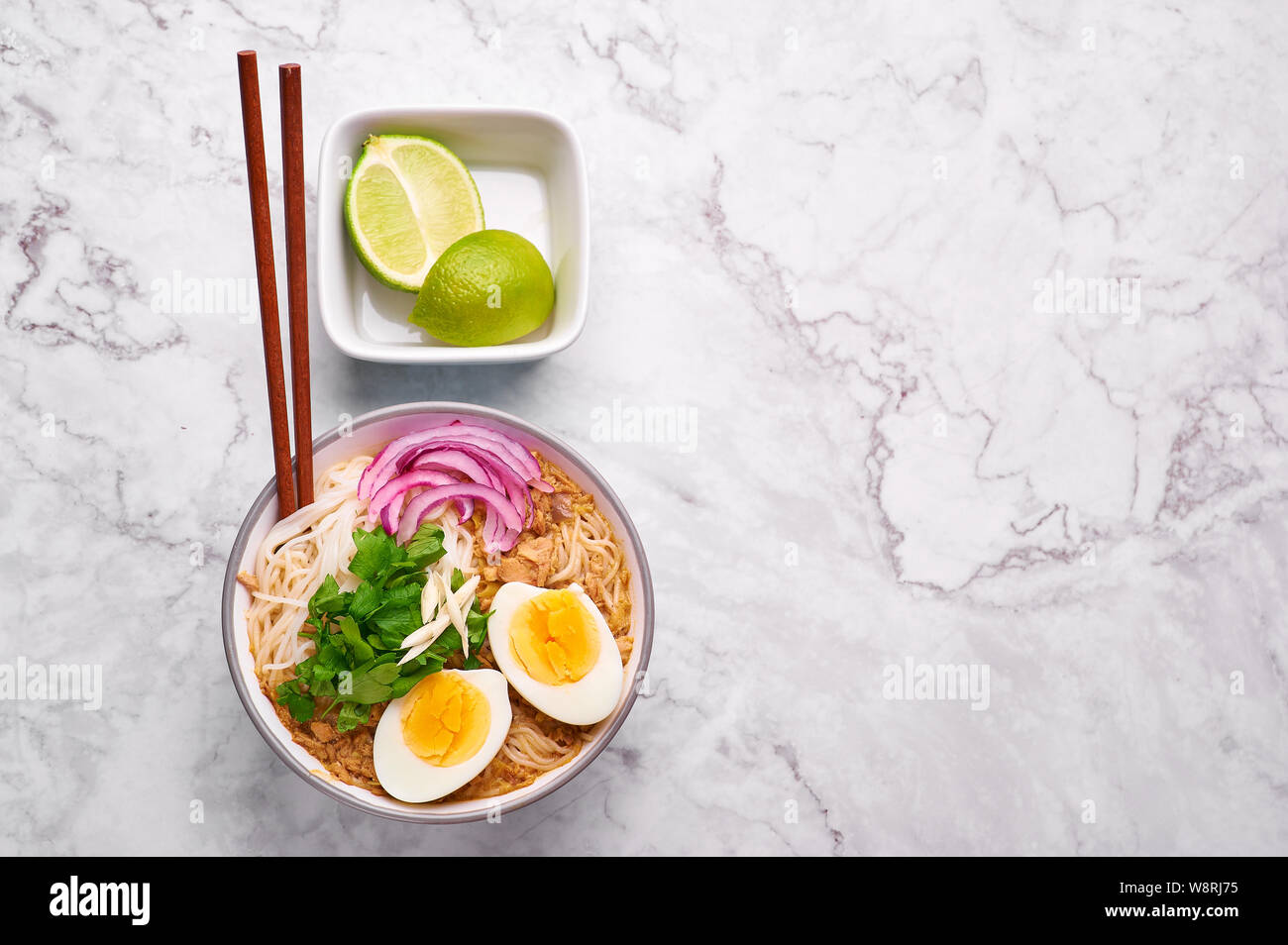 Mohinga at white marble background. Mohinga is a burmese cuisine fish ...