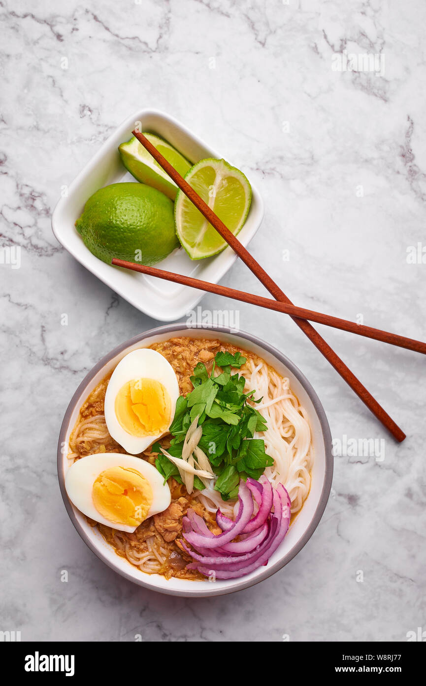 Mohinga at white marble background. Mohinga is a burmese cuisine fish ...