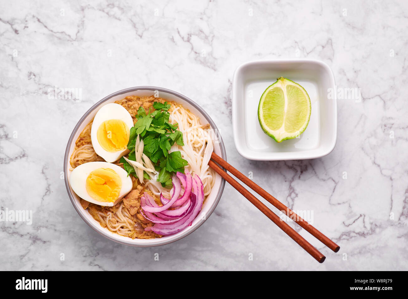 Mohinga at white marble background. Mohinga is a burmese cuisine fish ...