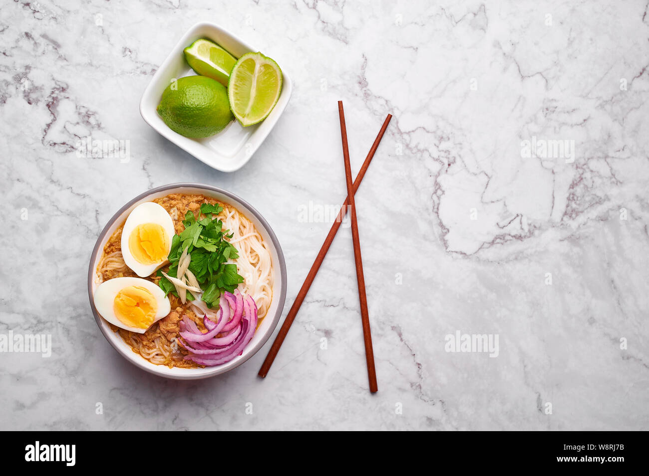 Mohinga at white marble background. Mohinga is a burmese cuisine fish ...