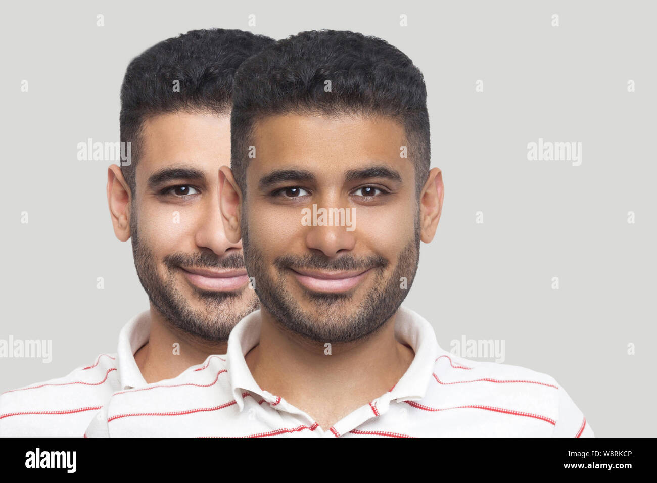 Closeup portrait of young brunette bearded man with different facial ...