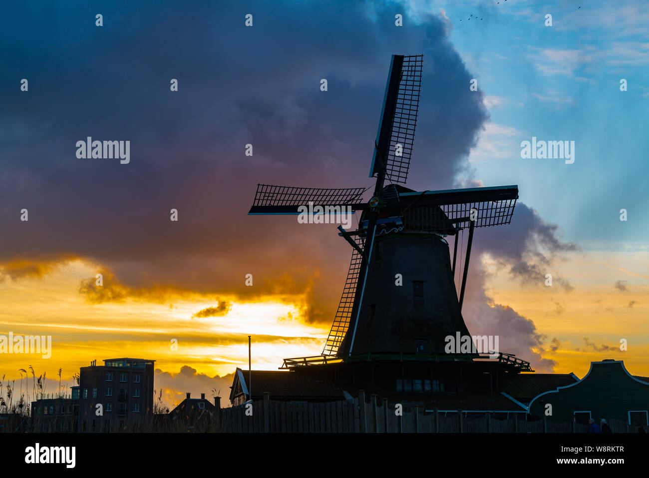 Silhouette of dutch windmill in the village of Zaanse Schans at sunset ...