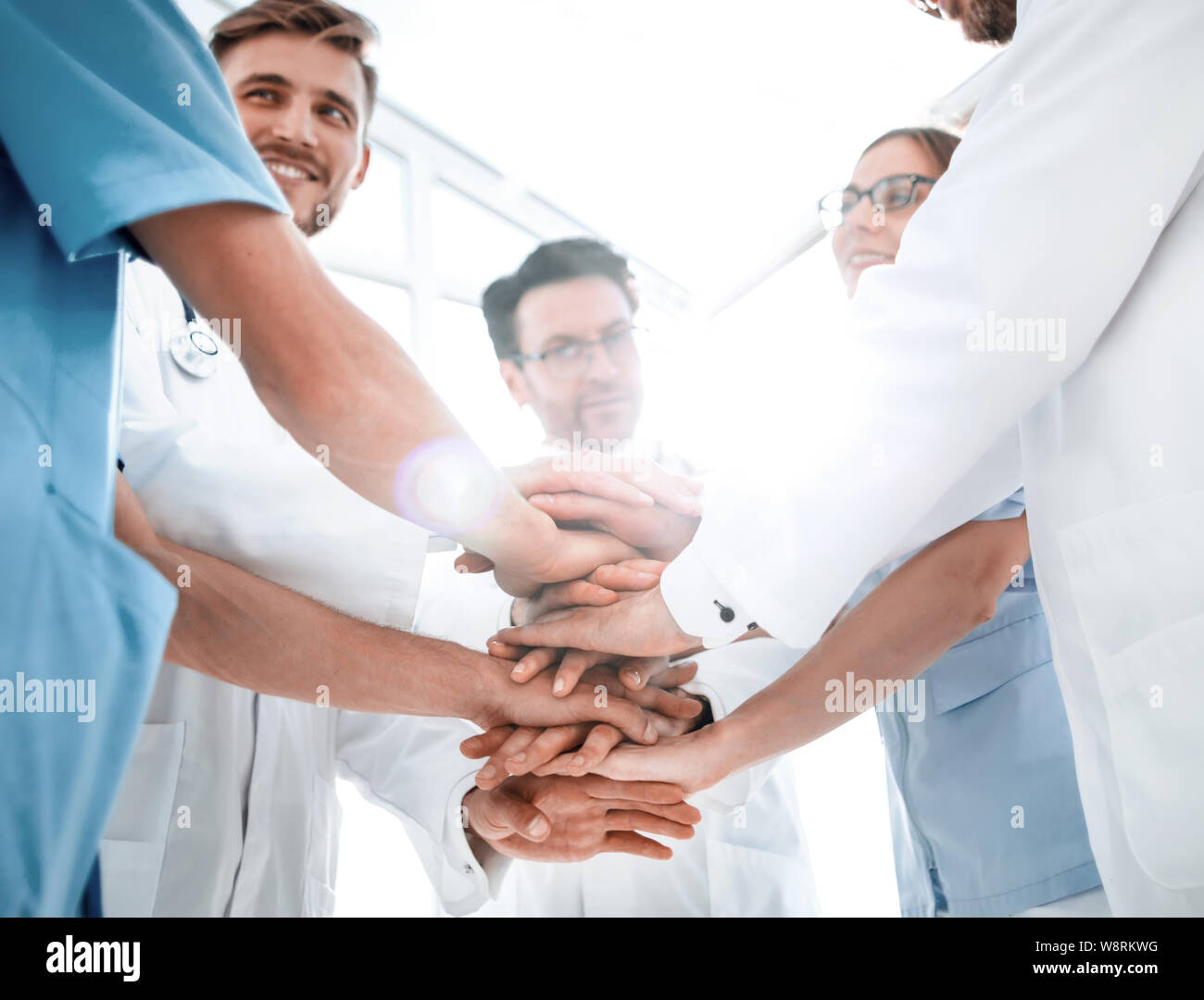 group of doctors with their hands folded together Stock Photo - Alamy