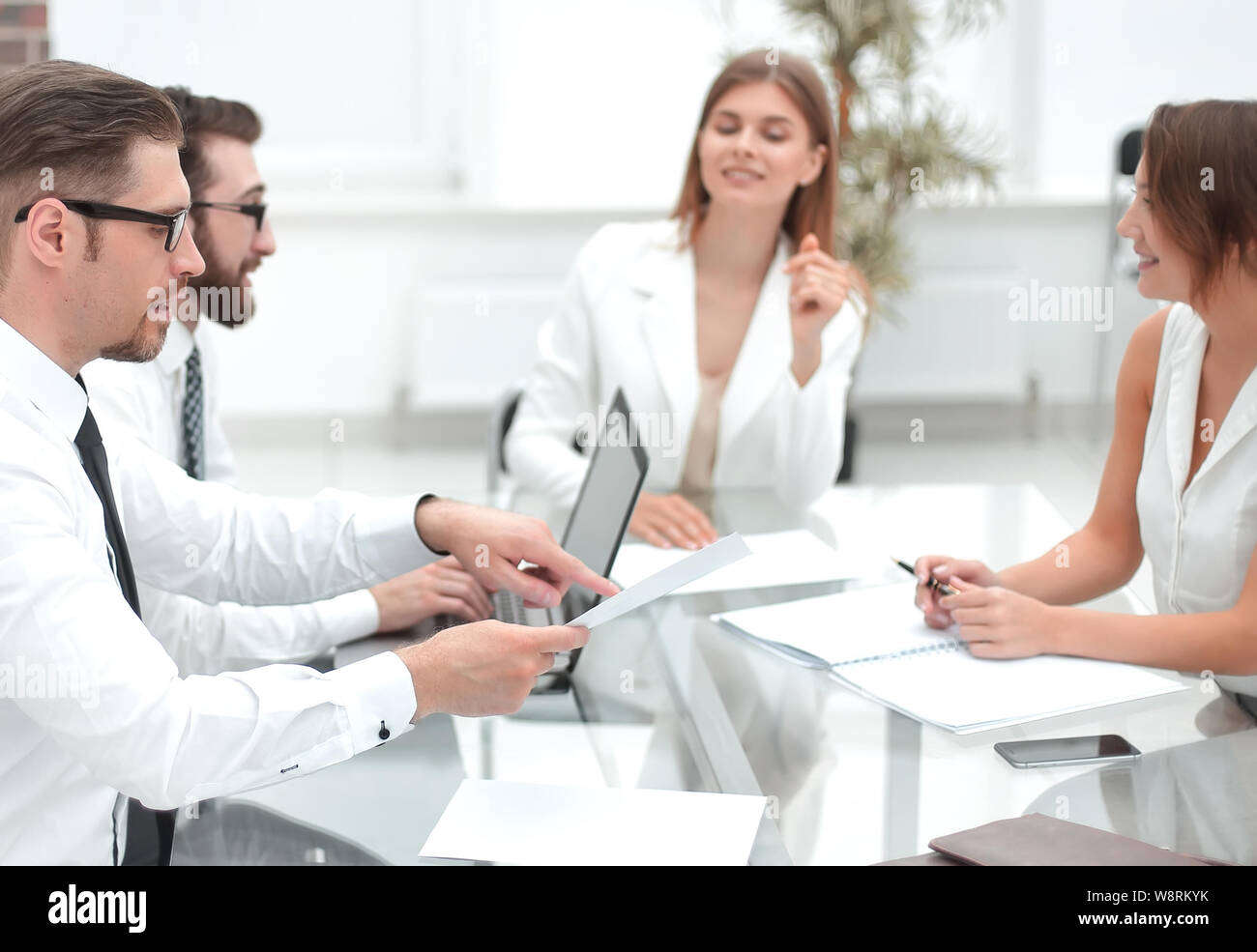 employees discussing business documents Stock Photo - Alamy