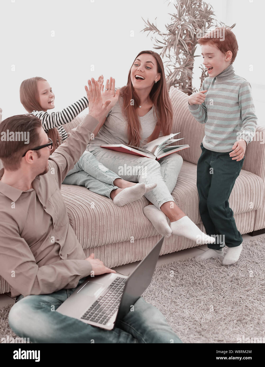 cheerful family spends their leisure time in their living room Stock ...