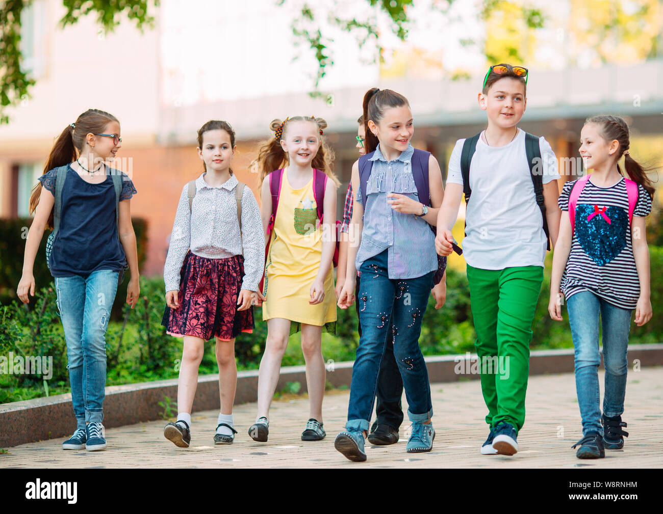 Group of kids going to school together Stock Photo - Alamy