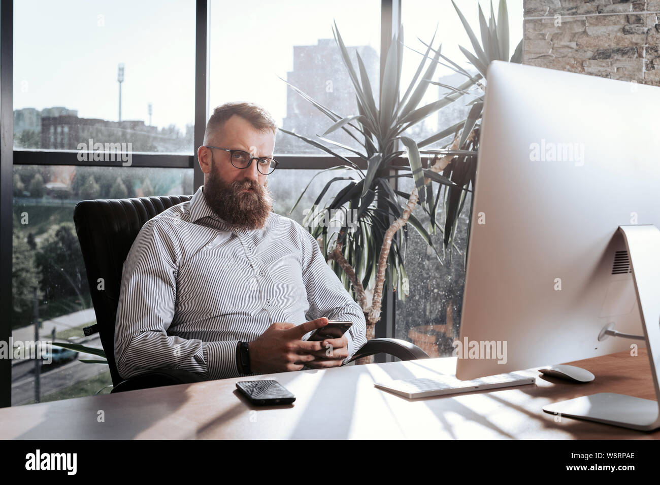 Portrait Of Businessman At Office Desk Using Computer Stock Photo - Alamy